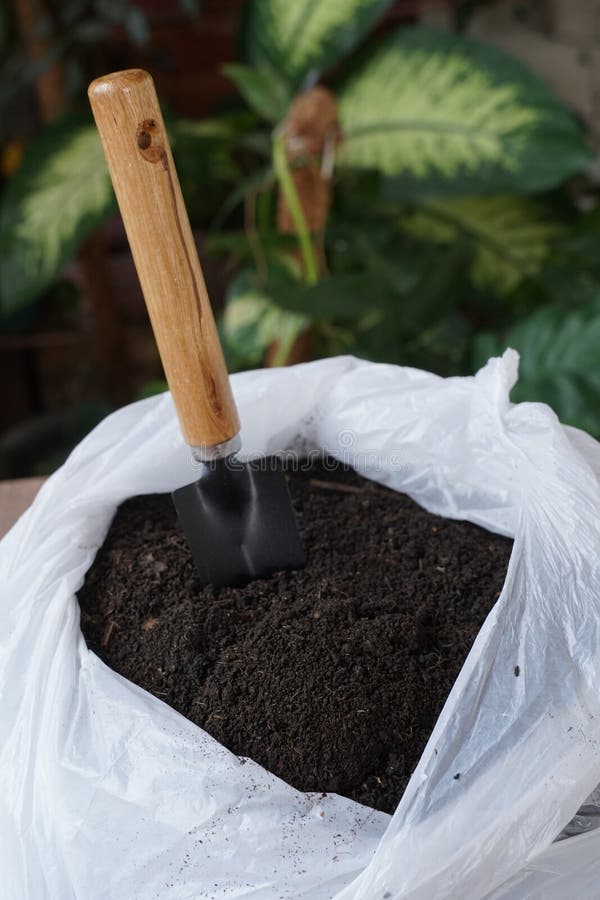 A Digging Tool on a Bag of Soil Photo Stock Photo - Image of device ...