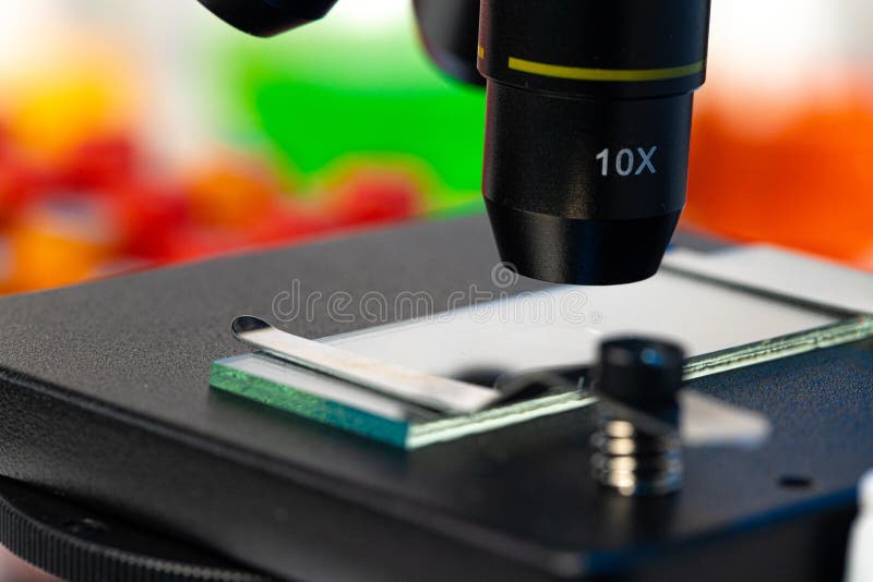 Close Up Photo of a Microscope Lenses Examining Glass Sample Stock ...