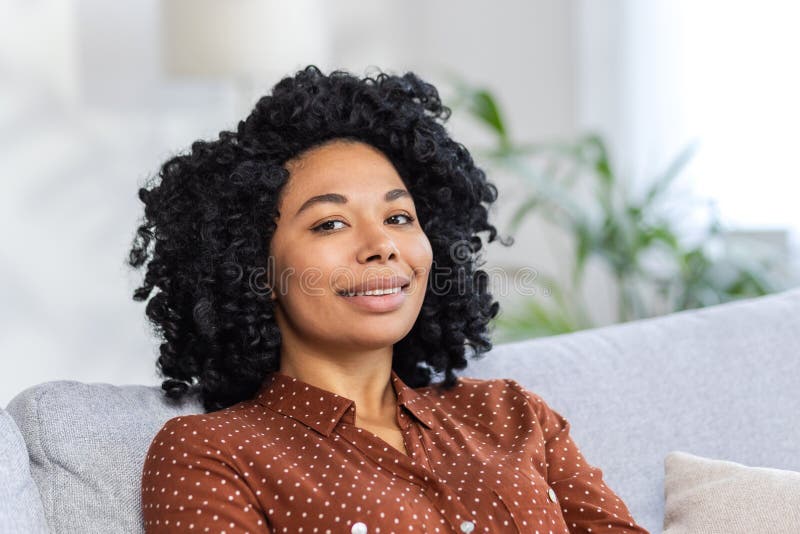 Close Up Photo Of A Relaxed African American Woman Sitting On The Couch