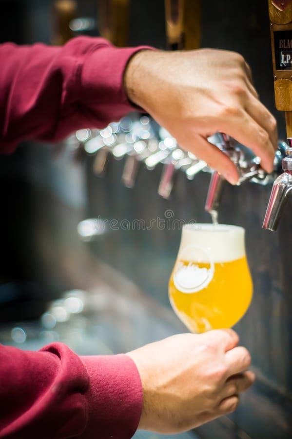 Close Up Photo of Some Beer Taps and a Man Serving Stock Image - Image ...