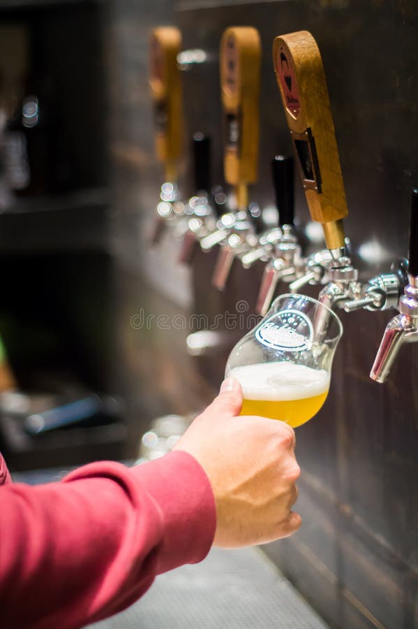 Close Up Photo of Some Beer Taps and a Man Serving Stock Image - Image ...