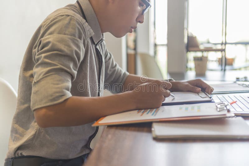 Close Up Photo of Young Man Reading Report Document Stock Photo - Image ...