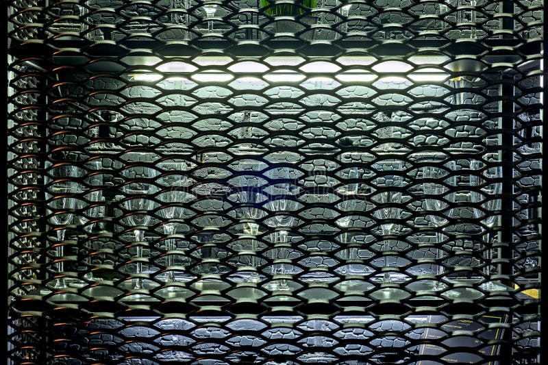 A Close Up of a Metal Screen with a Light Shining through it Stock ...