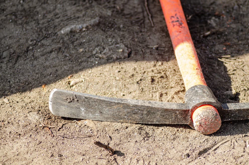 Close-up of a Pickaxe Lying on the Ground at a Work Site, Featuring a ...