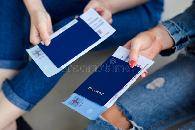 Close Up Picture Of Female Hands Holding Blue International Passports