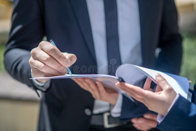 Close Up Picture of a Mans Hand Signing the Document Stock Image ...