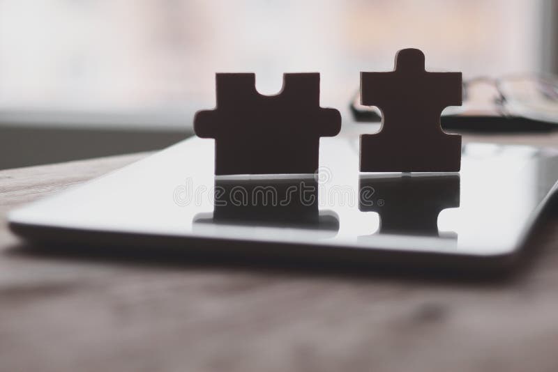 Close Up.piece of the Puzzle on the Screen of the Tablet on the Desktop ...