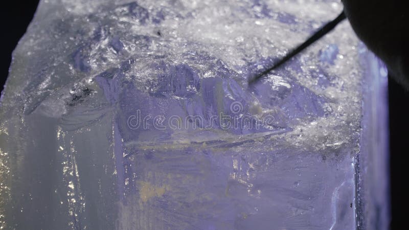 Close Up of Pieces of Ice Being Broken Off with a Chisel, Artist ...