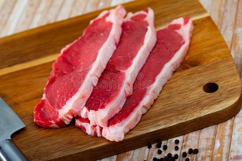Close Up of Pieces of Marbled Beef on Wooden Table Stock Photo - Image ...
