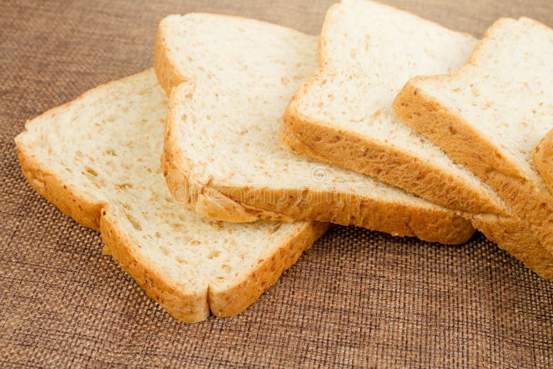 Pile Slice of Whole Wheat Bread on Dark Brown Calico. Stock Image ...