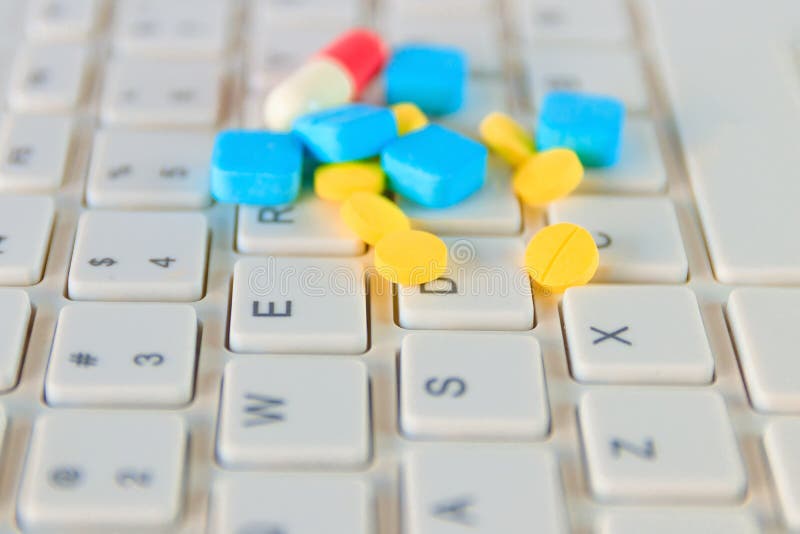 Close Up Pills and Capsule on Computer Keyboard White Concept with Copy ...