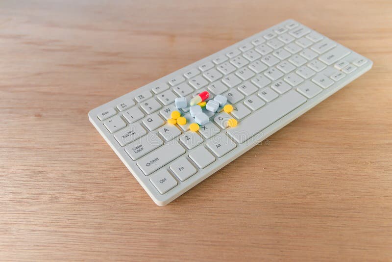 Close Up Pills and Capsule on Computer Keyboard White Concept with Copy ...