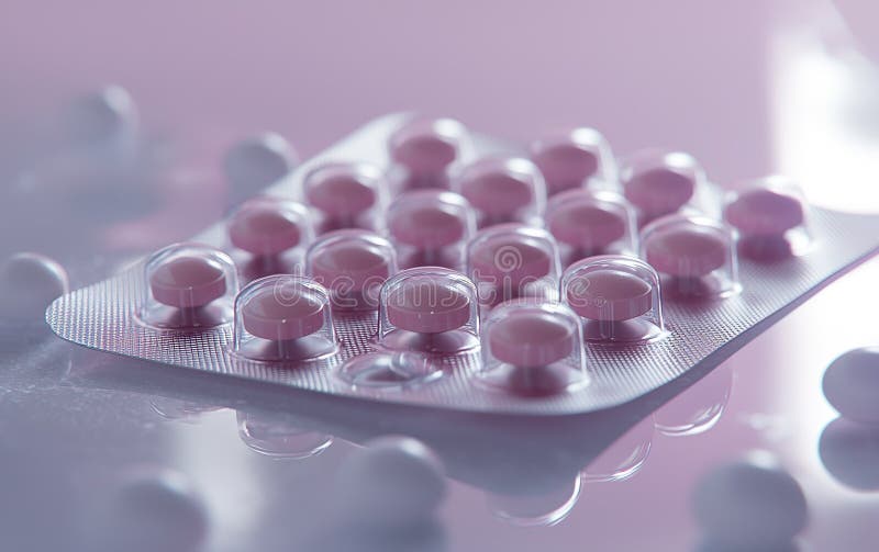 Close-up of Pink Tablets in a Blister Pack on a Reflective Surface ...