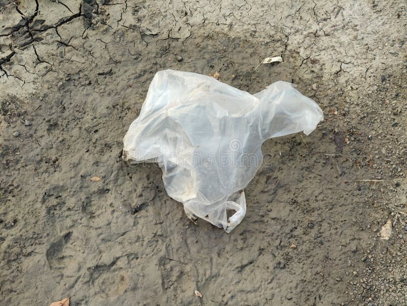 Plastic bag on the ground stock image. Image of pollute - 315433629