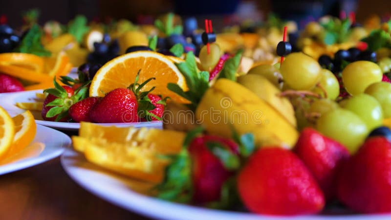 Close-up of Plates with Different Types of Fruit and Berries on a ...