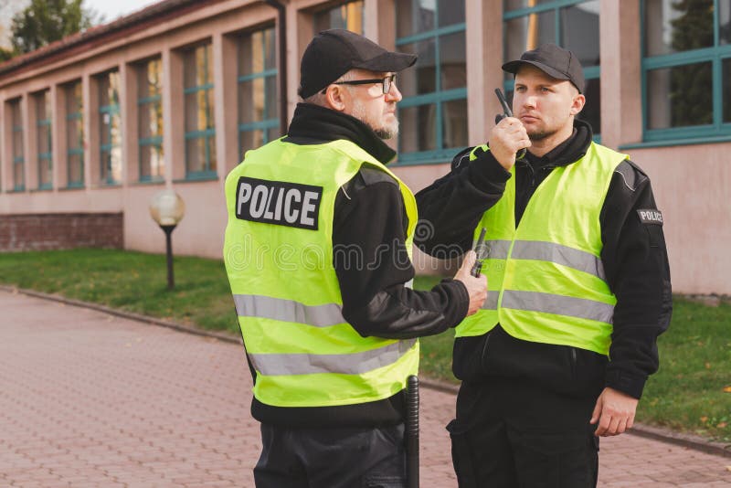 Policemen Speaking on the Walkie-talkie, Reporting To Station Stock ...