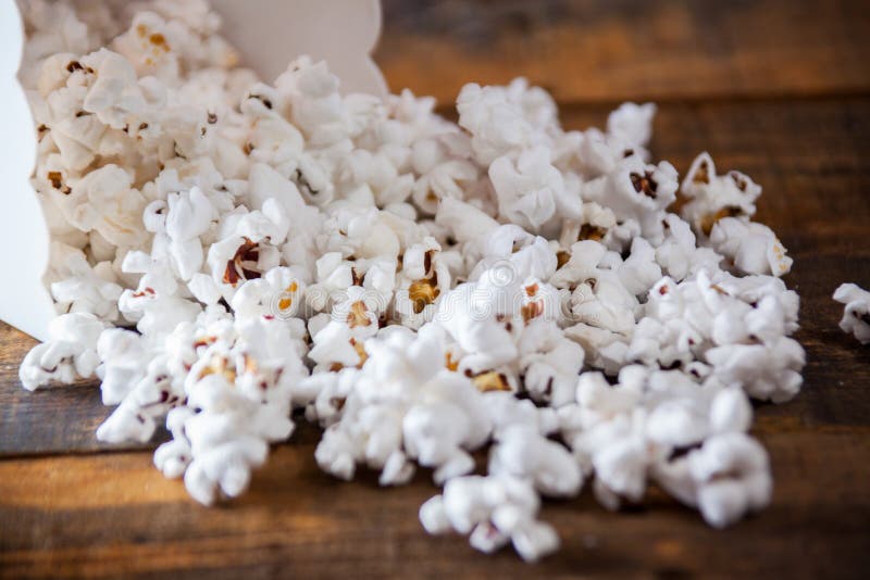 Close Up of Popcorn Spilled Out on a Wooden Table with Selective Stock ...