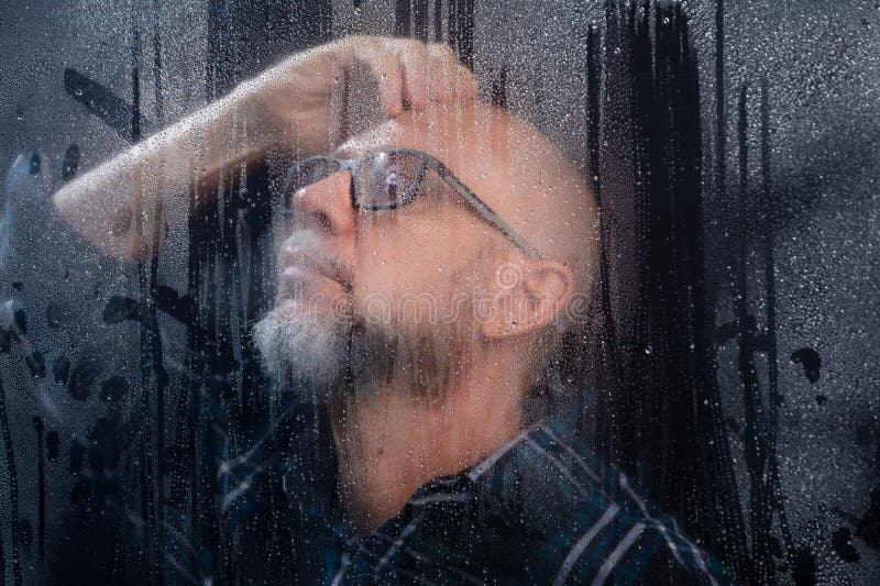 Close Up Portrait Of Bald Bearded Man Wearing Prescription Glasses