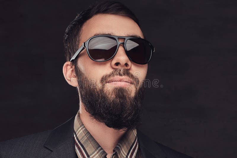 Close Up Portrait Of A Bearded Man Wearing A Suit And Sunglasses Stock
