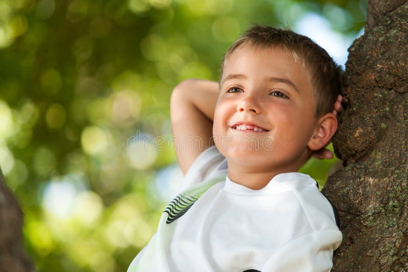 Cute Boy Relaxing on Tree Trunk. Stock Photo - Image of climbing, human ...
