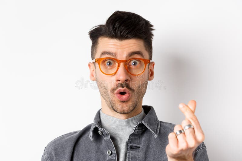 Close Up Portrait Of Cute Guy With Moustache Wearing Glasses Showing Hand Heart Sign Look