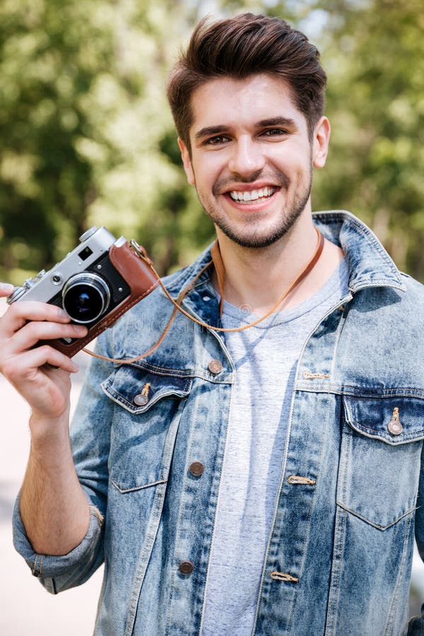 Handsome Hipster Guy Holding Camera Wearing Hat Outdoors Stock Image ...