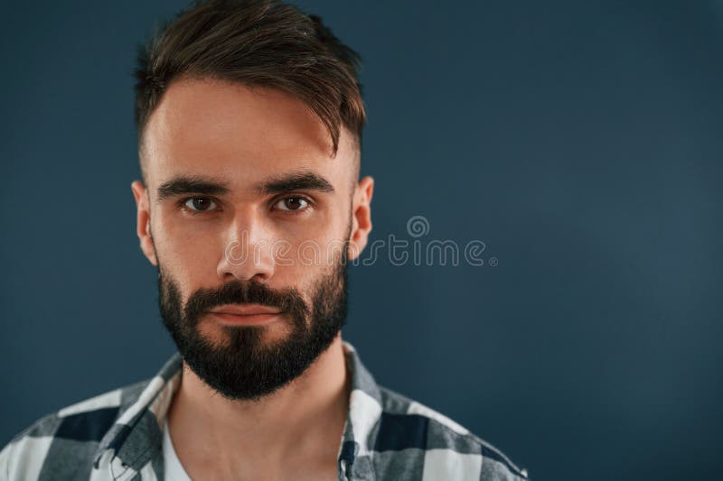 Close Up Portrait. Handsome Man is in the Studio Against Blue ... Close Up Portrait. Handsome Man is in the Studio Against Blue ...