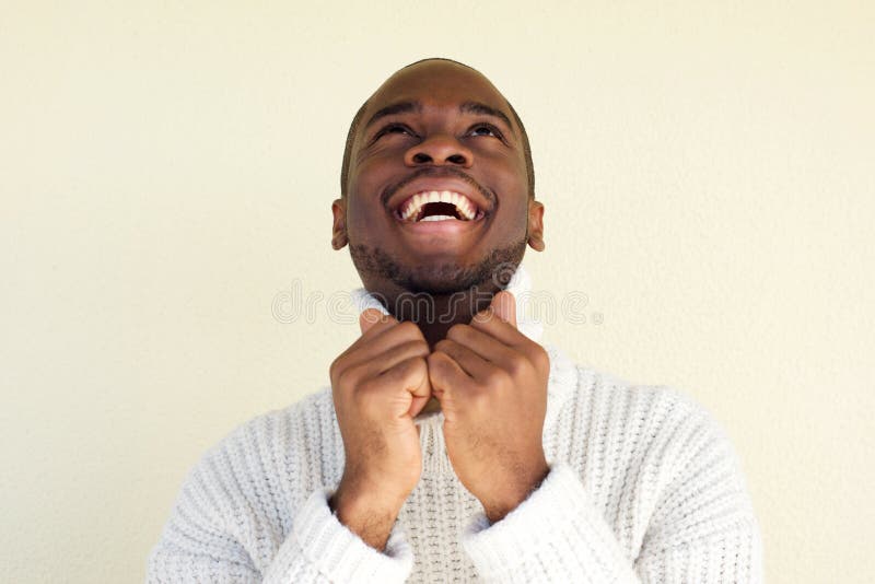 Close Up Handsome Young Black Man Laughing with Sweater and Looking Up ... Close Up Handsome Young Black Man Laughing with Sweater and Looking Up ...