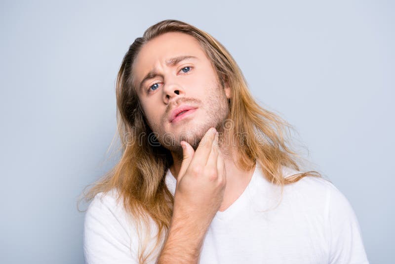 Close Up Portrait Of Handsome Young Guy Touching His Stubble Before