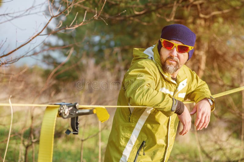 Close-up Portrait of a Man Adjusting Slacklining Equipment before ...