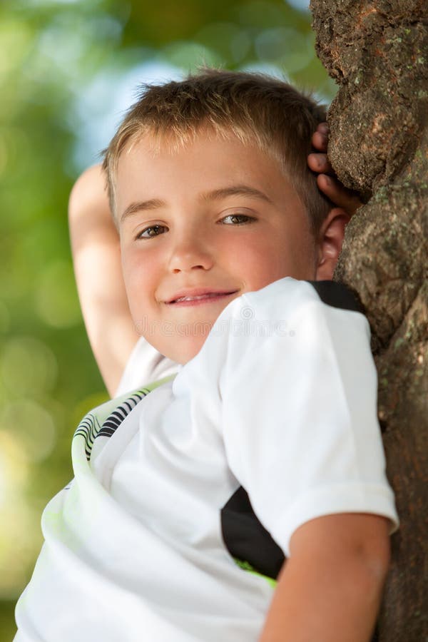 Portrait of Cute Boy Resting in Tree. Stock Image - Image of face ...