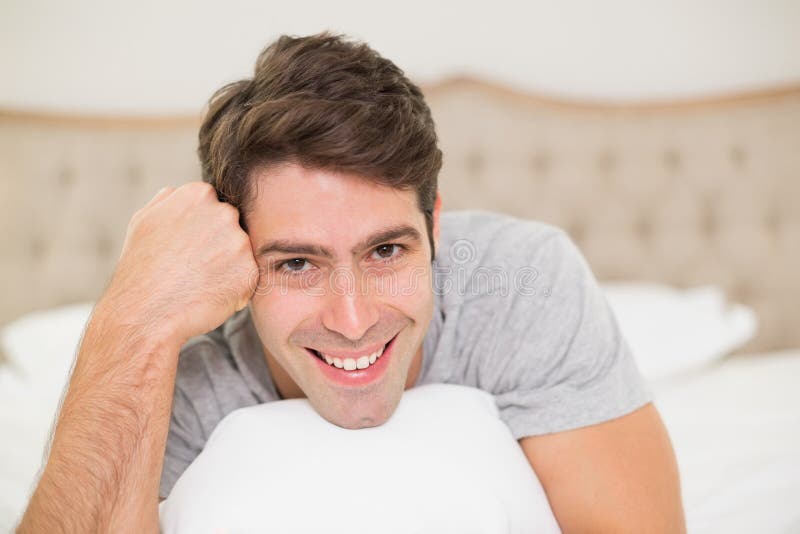 Close Up Portrait of a Smiling Man Resting in Bed Stock Photo - Image ...