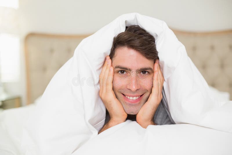 Close Up Portrait of a Smiling Man Resting in Bed Stock Photo - Image ...