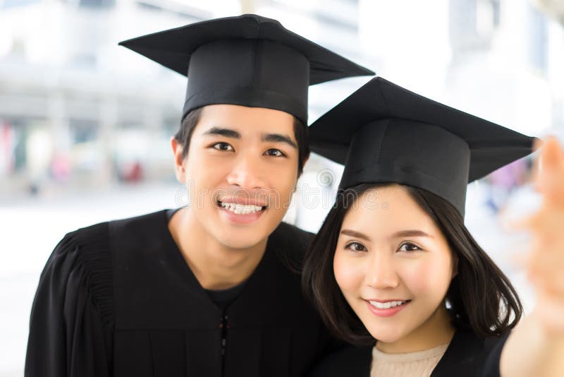 Close Up Portrait of Two Happy Graduating Students Using a Smart Stock ...