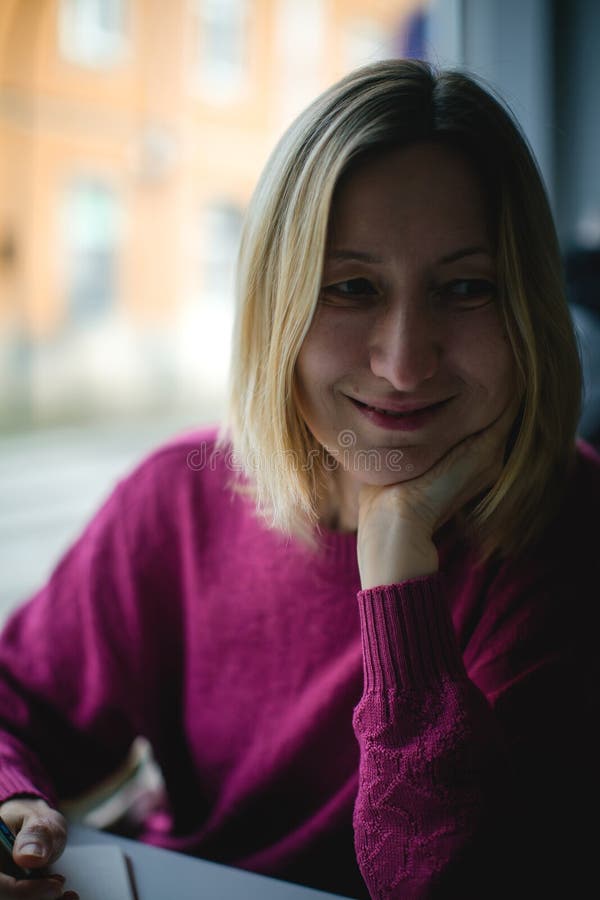 A Close-up Portrait of a Woman Writing in a Notebook Stock Image ...