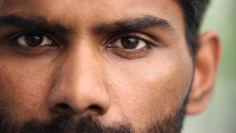 Close Up Portrait of a Young Serious Man Looking at the Camera. he is ... Close Up Portrait of a Young Serious Man Looking at the Camera. he is ...