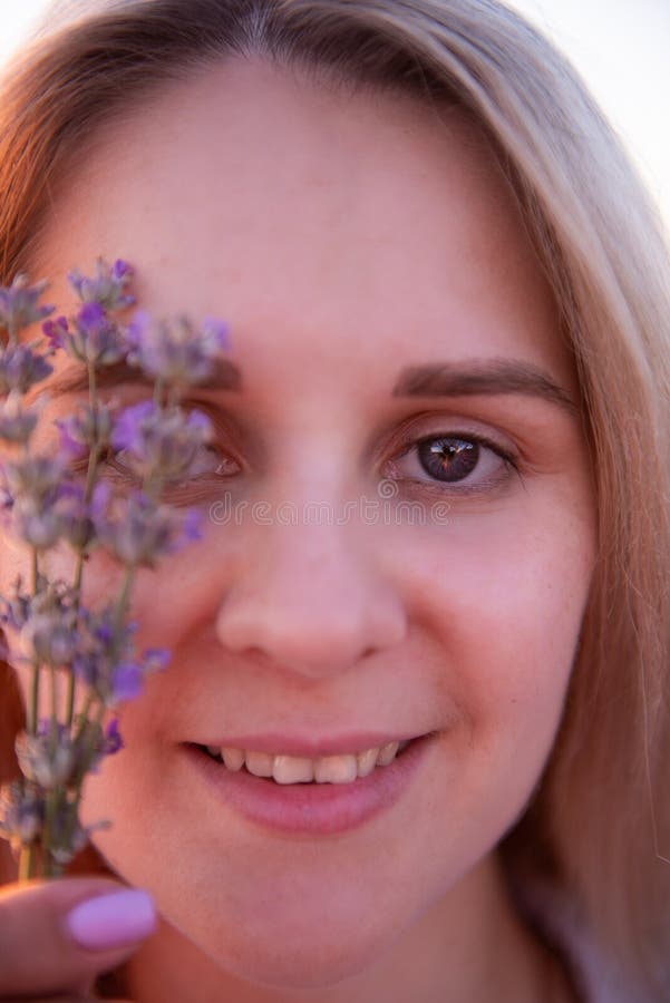 Close Up Portrait Of Young Woman With Bouquet Of Purple Lavender In