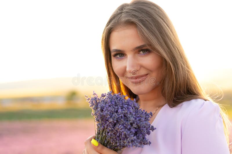 Close Up Portrait Of A Young Woman Holding Bouquet Of Lavender Whiile