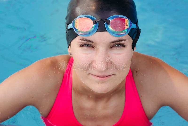 Sporty Woman In Cap Swimming In The Blue Water Pool Stock Image
