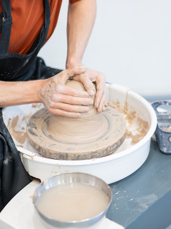Close-up of a Potter& X27;s Hands Working on a Pottery Wheel. Vertical ...