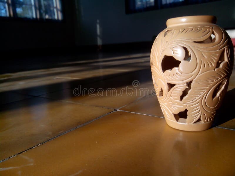 Close Up Pottery Brown Color with Light Coming from the Side on Floor ...