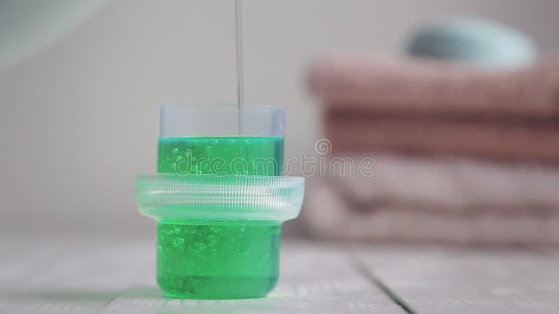 Liquid Laundry Detergent or Fabric Softener on Bedding, Flowers Falling ...