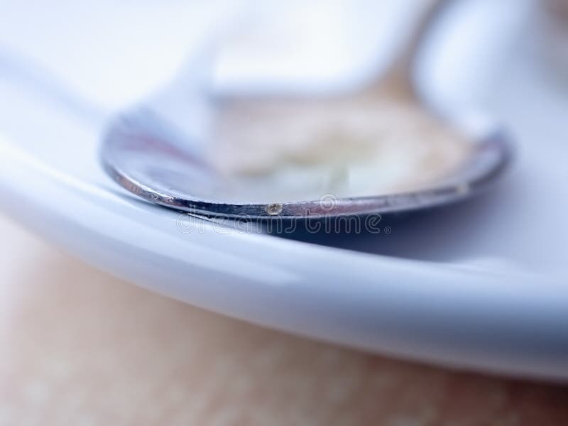 Front Edge of a Small Spoon on a Small Plate Stock Image - Image of ...