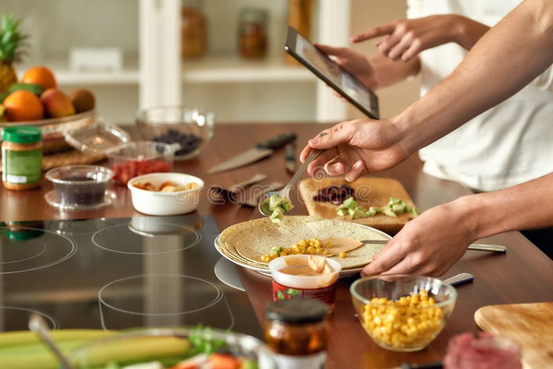 Close Up of Process of Cooking. Man Preparing Meal while Woman Checking ...