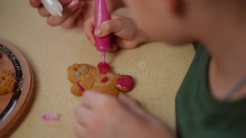 Close-up. the Process of Decorating a Gingerbread Man with a Pink ...