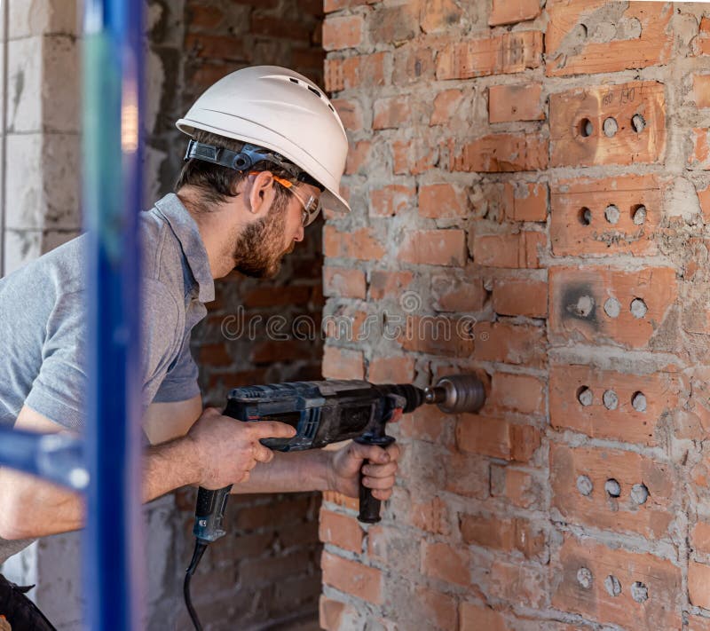 The Builder Works with a Drill in Working Form Stock Image - Image of ...