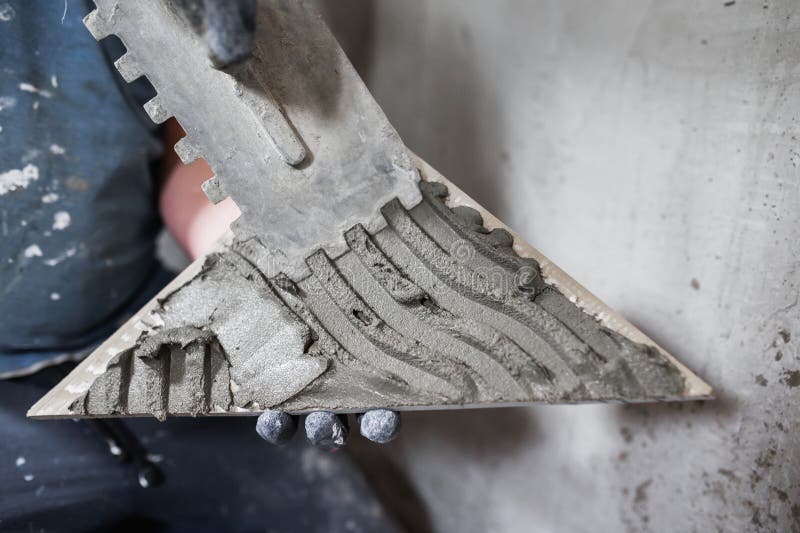 Close-up of the Process of Installing Tiles on the Floor and Wall Stock ...