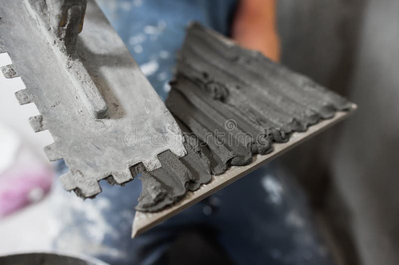 Close-up of the Process of Installing Tiles on the Floor and Wall Stock ...