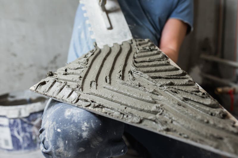 Close-up of the Process of Installing Tiles on the Floor and Wall Stock ...