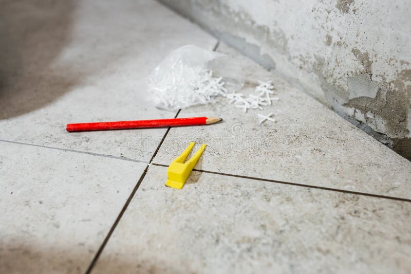 Close-up of the Process of Installing Tiles on the Floor and Wall Stock ...